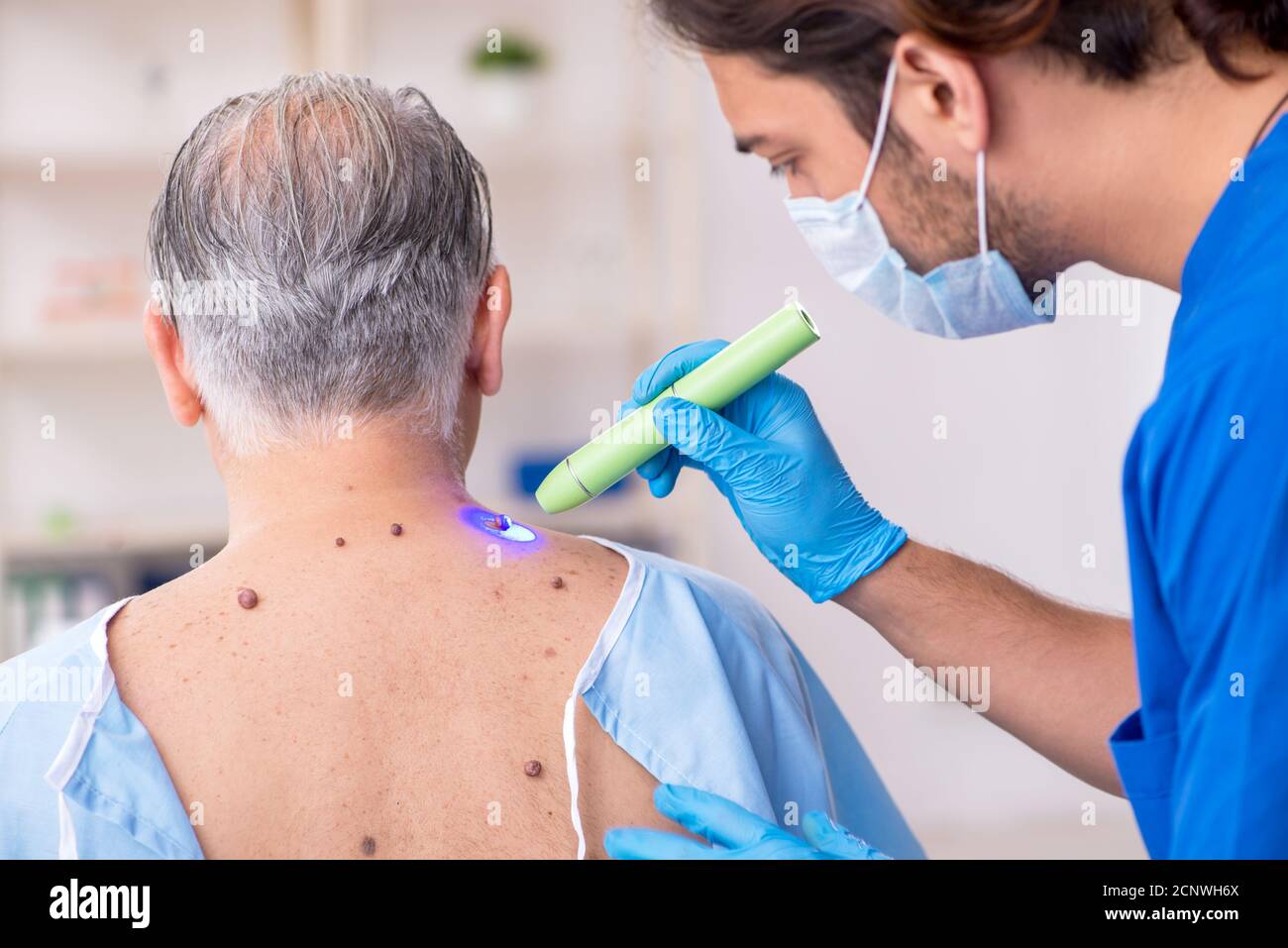 Old man visiting male doctor dermatologist Stock Photo - Alamy