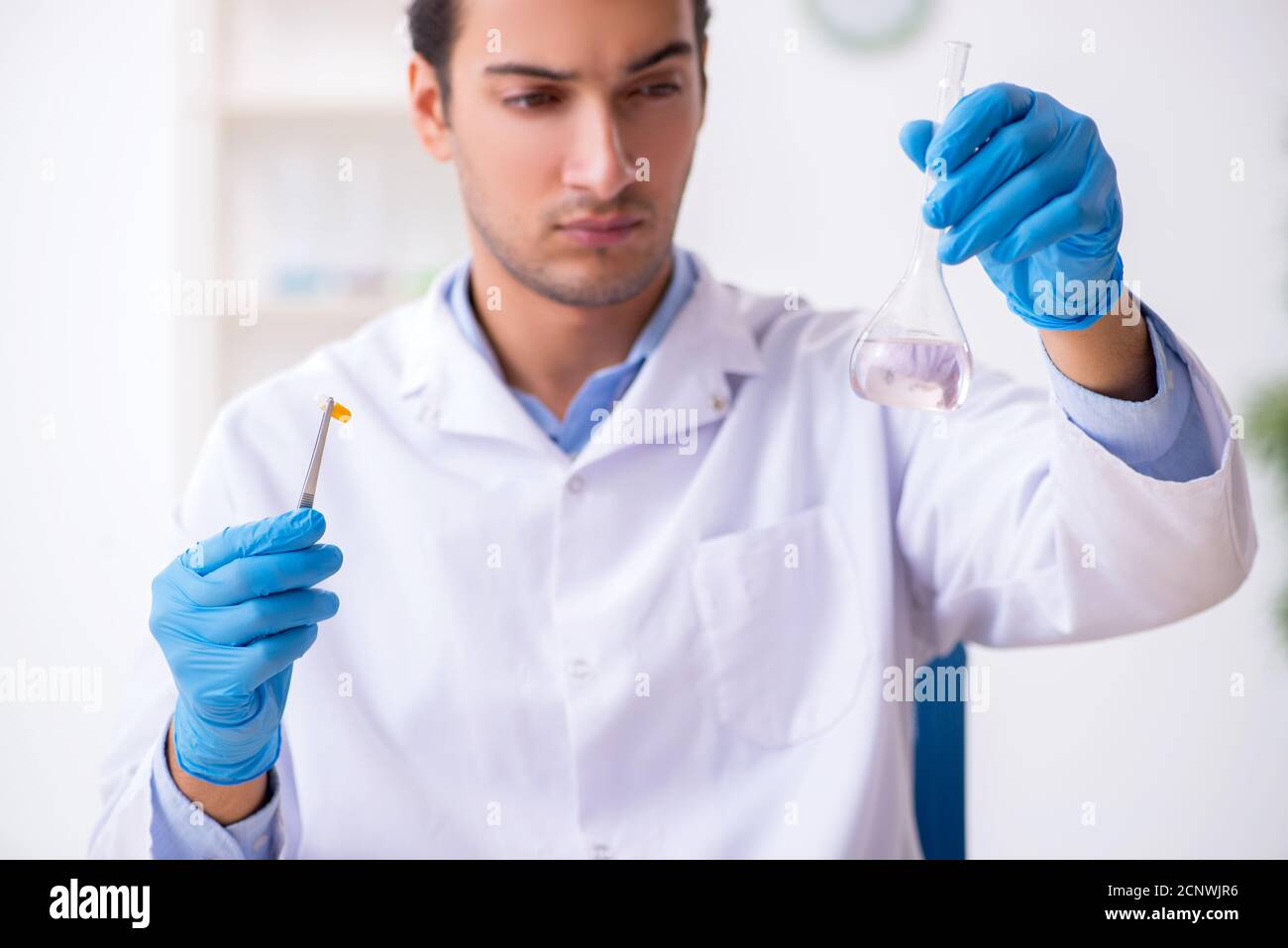 Young male lab assistant in the drug synthesis concept Stock Photo - Alamy
