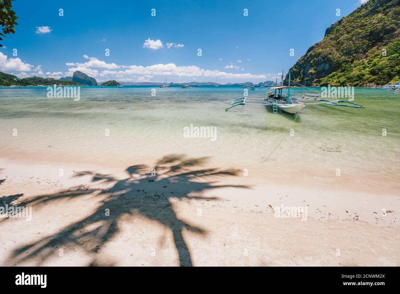Beautiful scenery of Corong Corong beach with traditional boat and palm ...