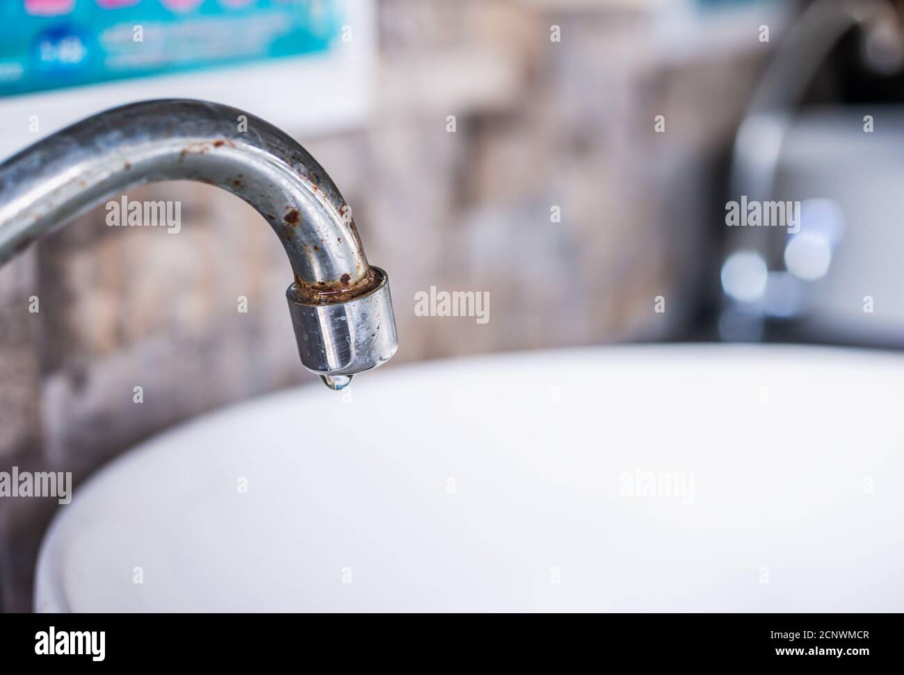 Water drop from old water tap blurred background, Save water cocept ...