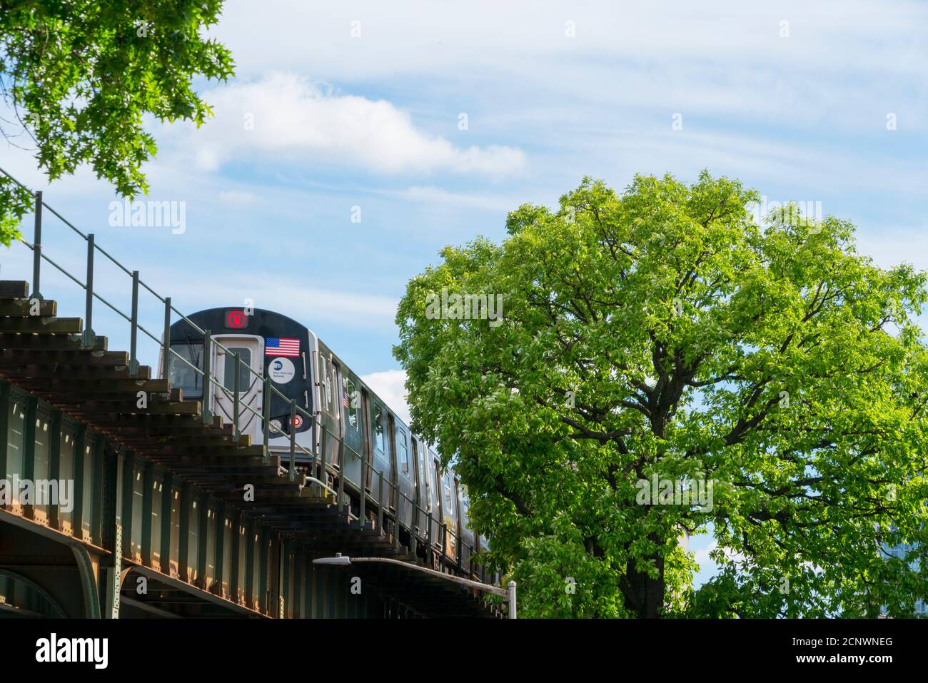 New York City subway runs on the elevated railway track at Queens New ...