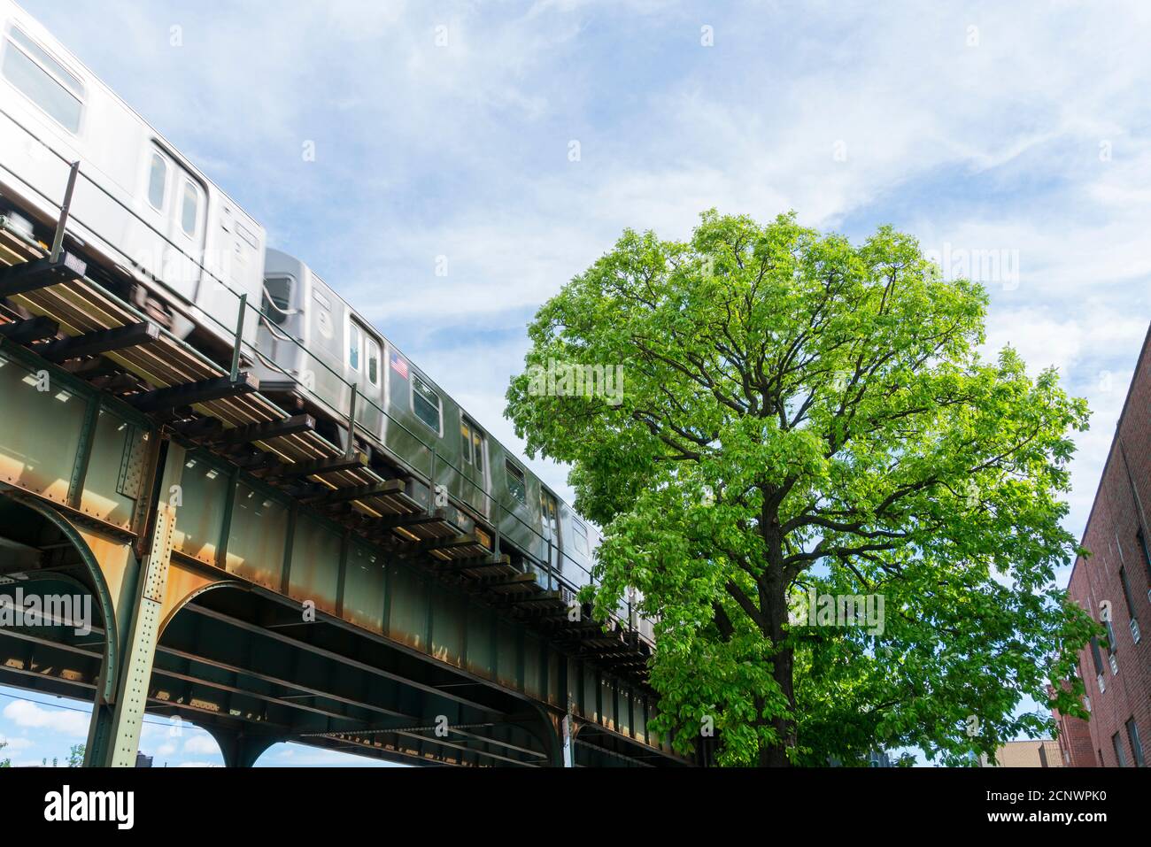 New York City subway runs on the elevated railway track at Queens New ...