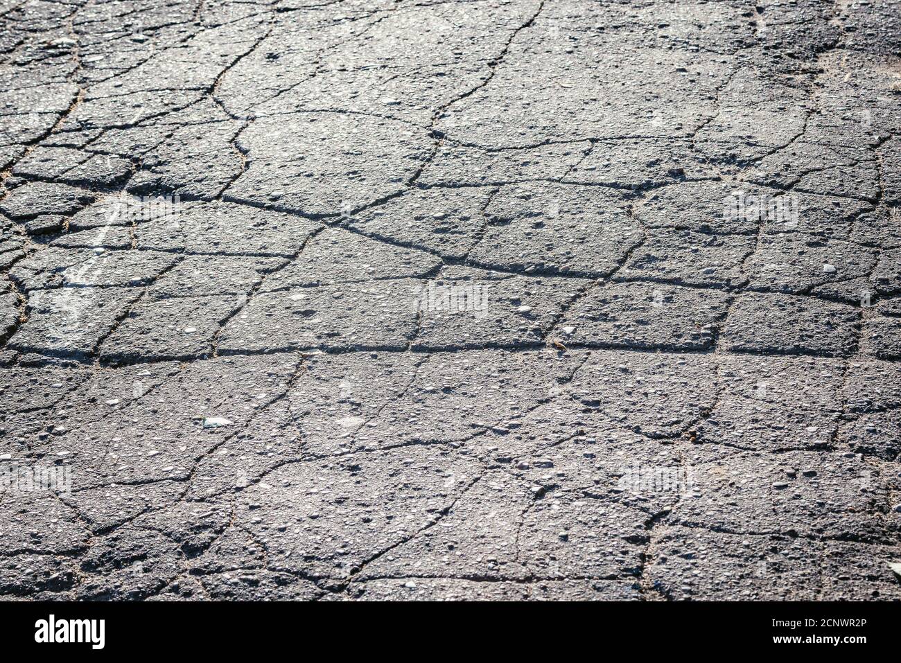 Cracked asphalt surface of the old road Stock Photo - Alamy