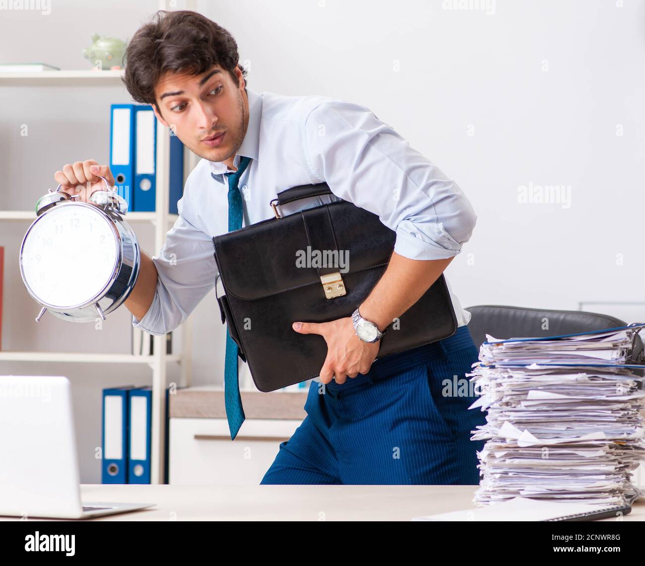 The overloaded busy employee with too much work and paperwork Stock ...