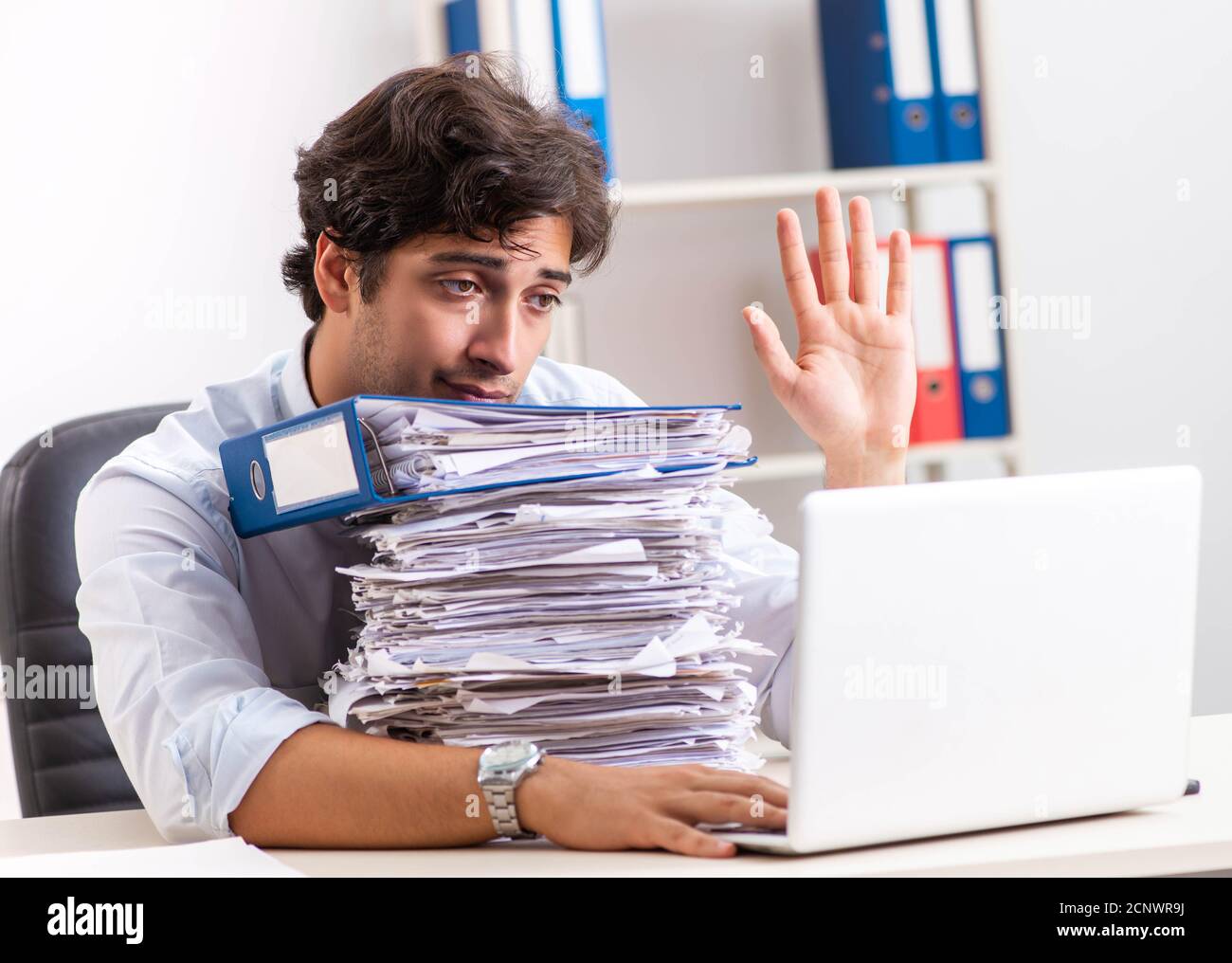 The overloaded busy employee with too much work and paperwork Stock ...
