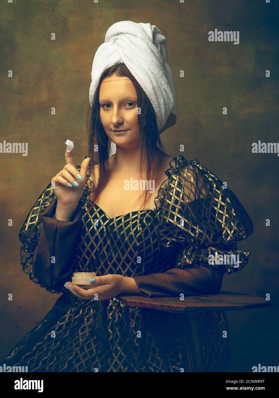 Beauty routine. Young woman as Mona Lisa, La Gioconda isolated on dark ...