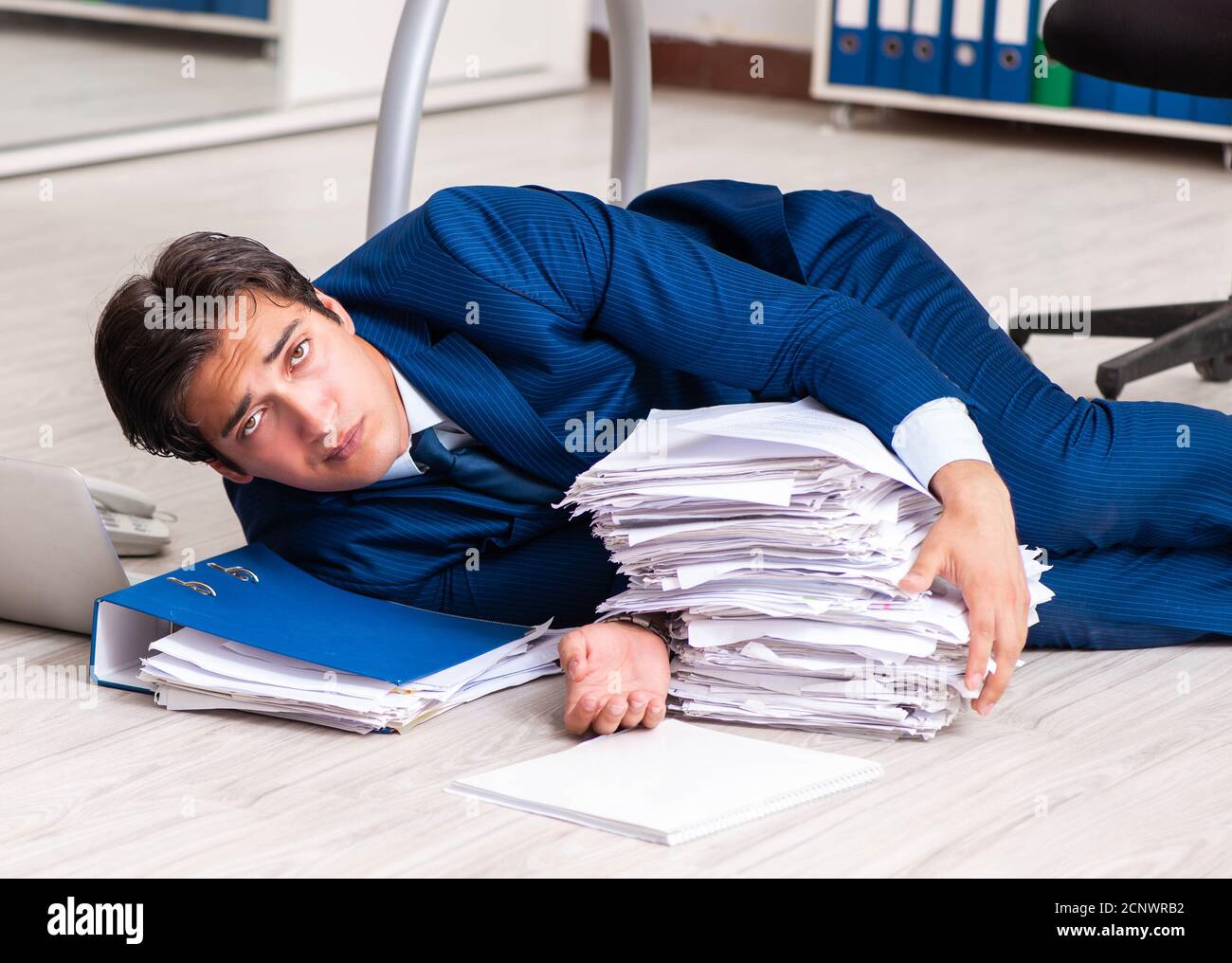 The tired exhausted businessman working overtime in office Stock Photo ...