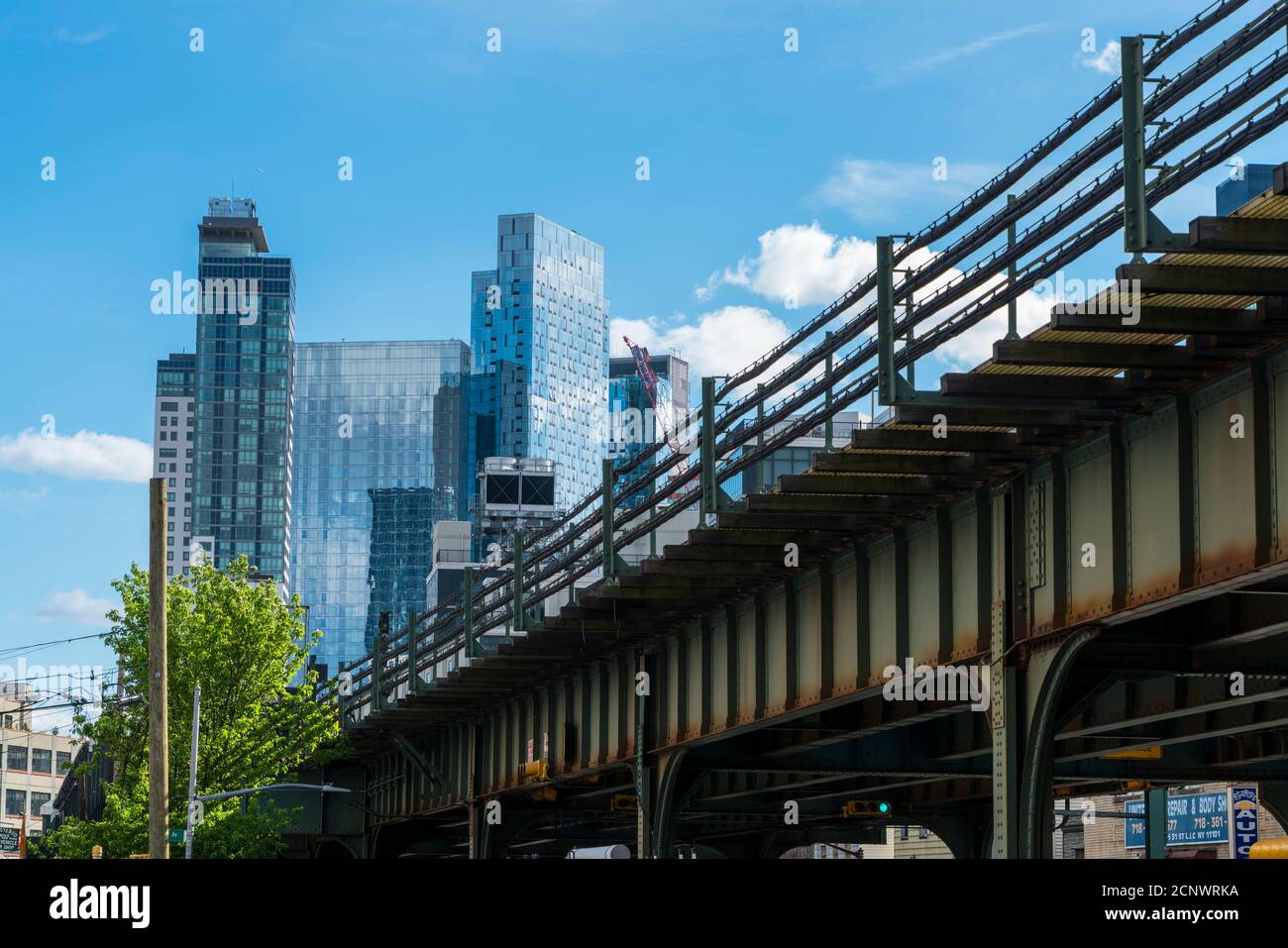 High-rise buildings stand behind elevated railway track at Queensboro ...