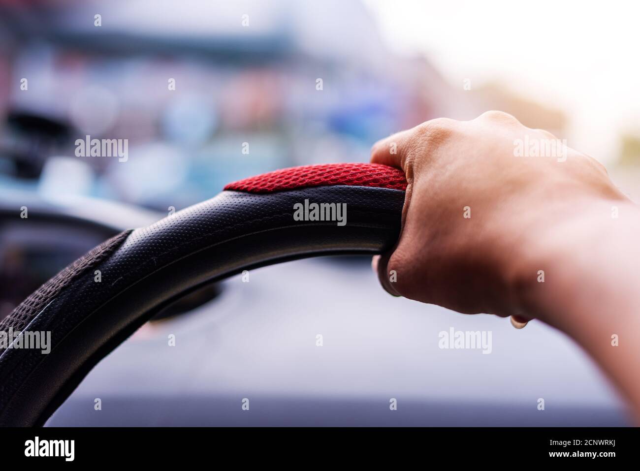 Driving concept, Hand driving a car on the road blurred background ...