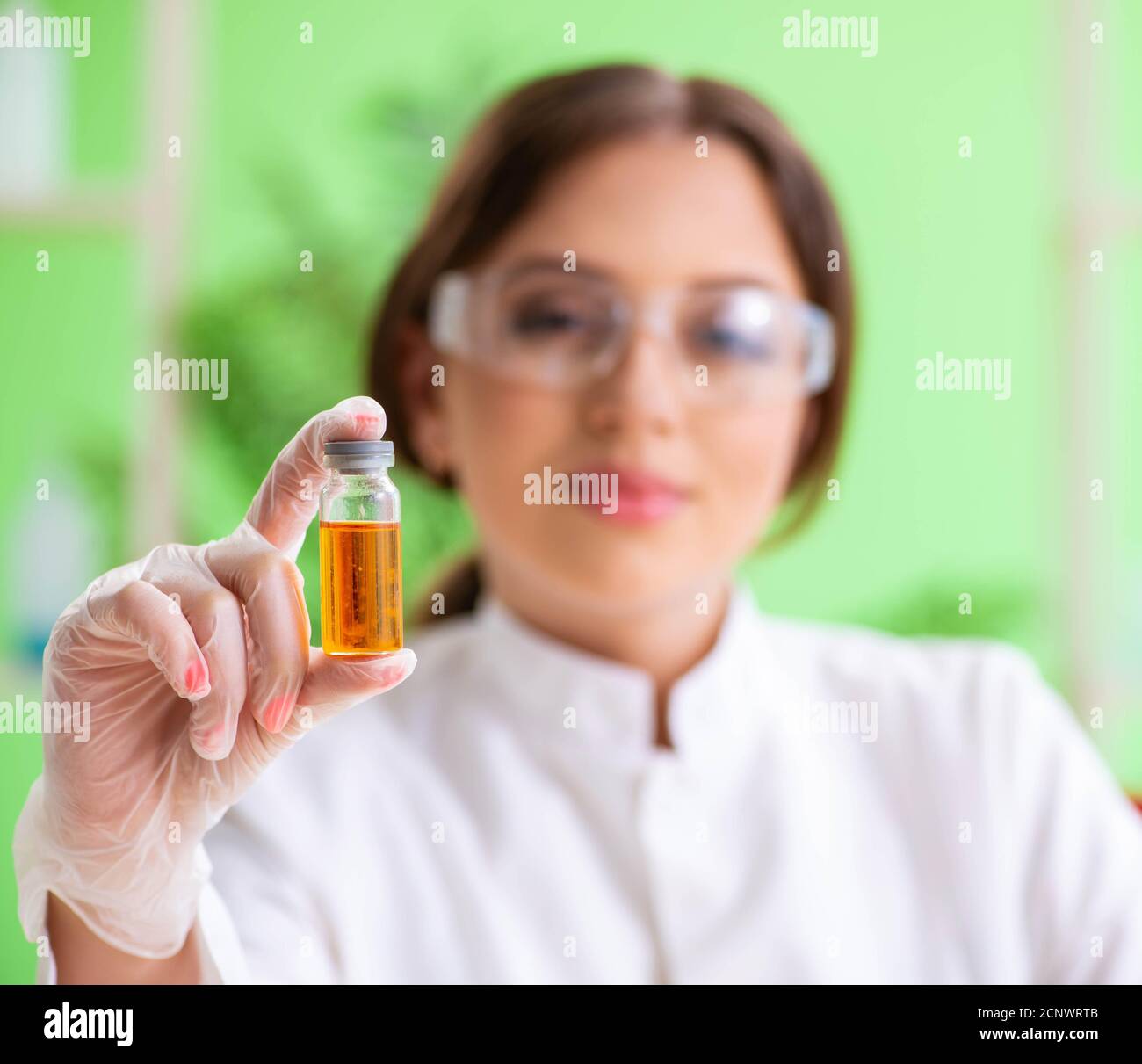 The beautiful female biotechnology scientist chemist working in lab ...