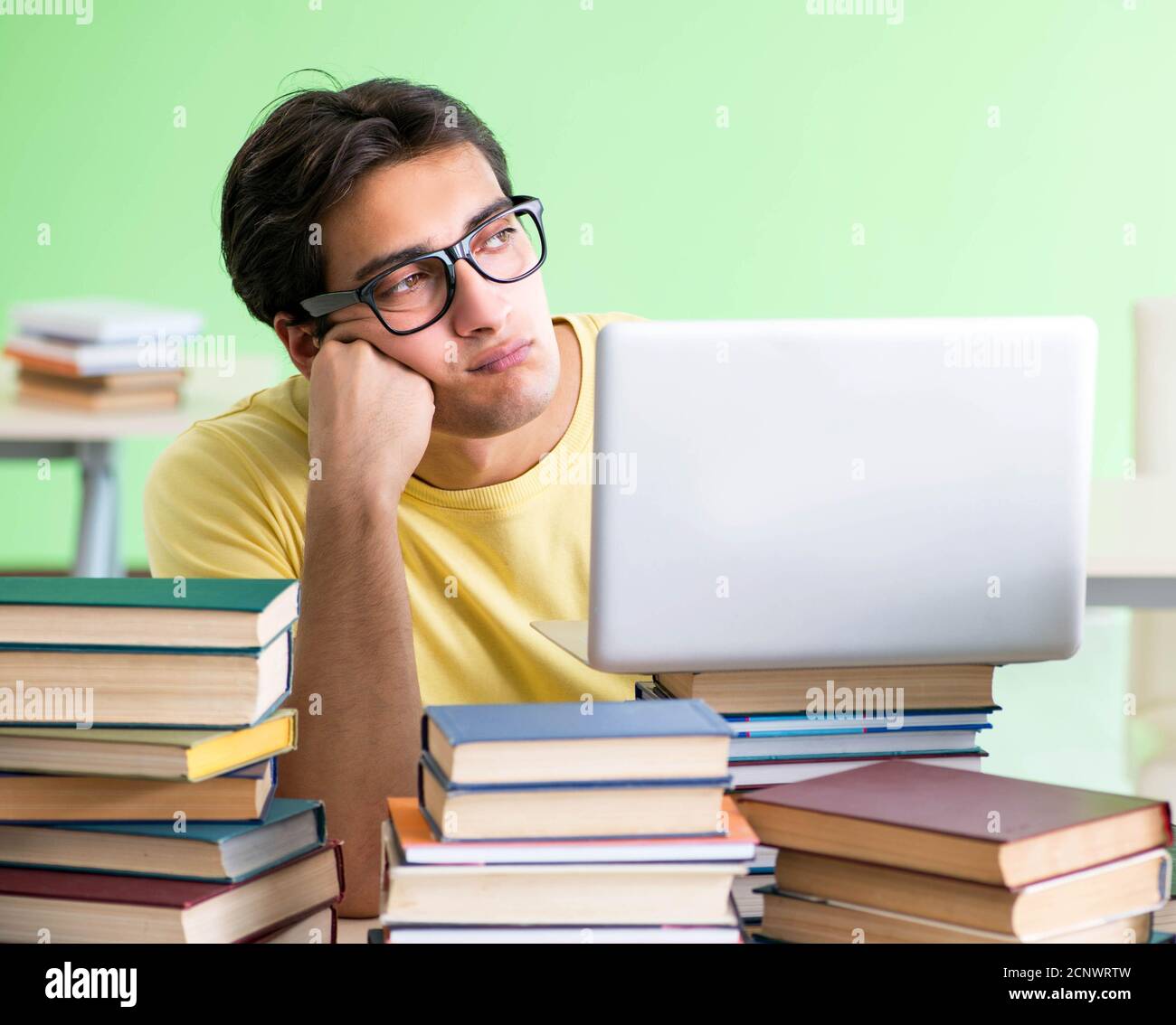 The student with too many books to read before exam Stock Photo - Alamy