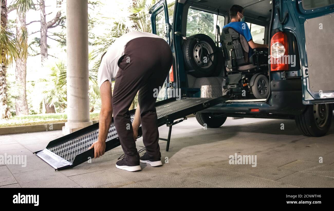 Man pushing wheel chair ramp hi-res stock photography and images - Alamy