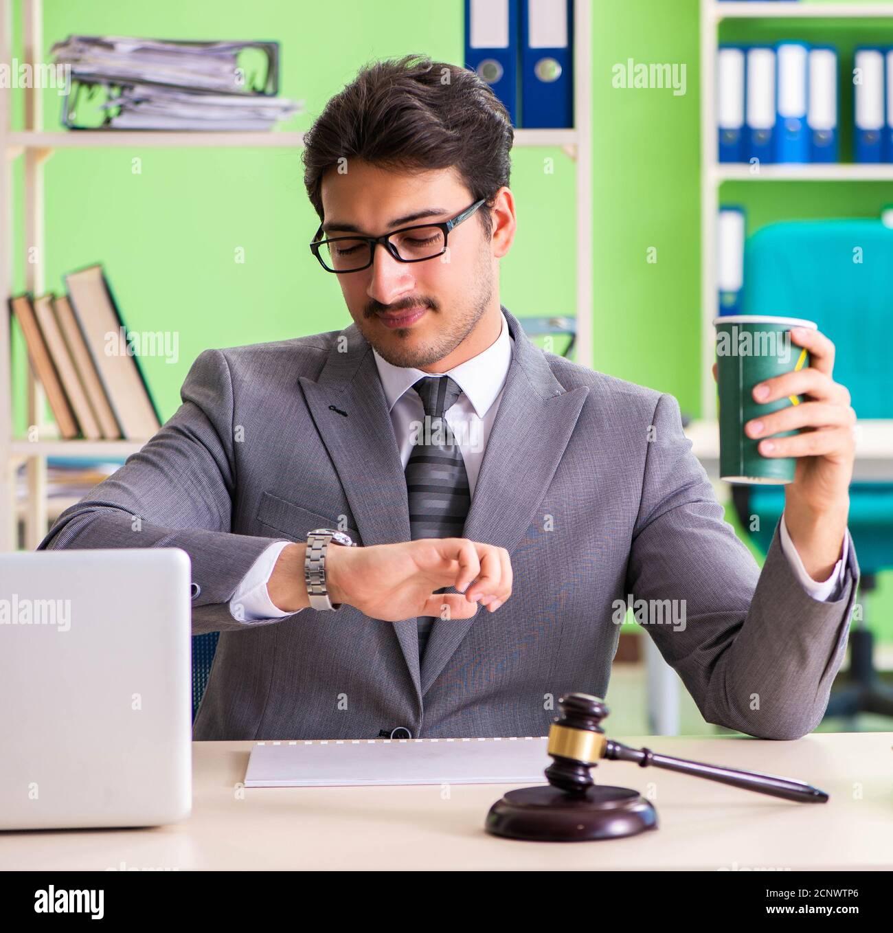 The young handsome lawyer working in the office Stock Photo - Alamy