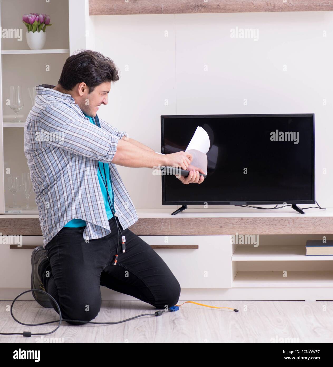 The man trying to fix broken tv Stock Photo - Alamy