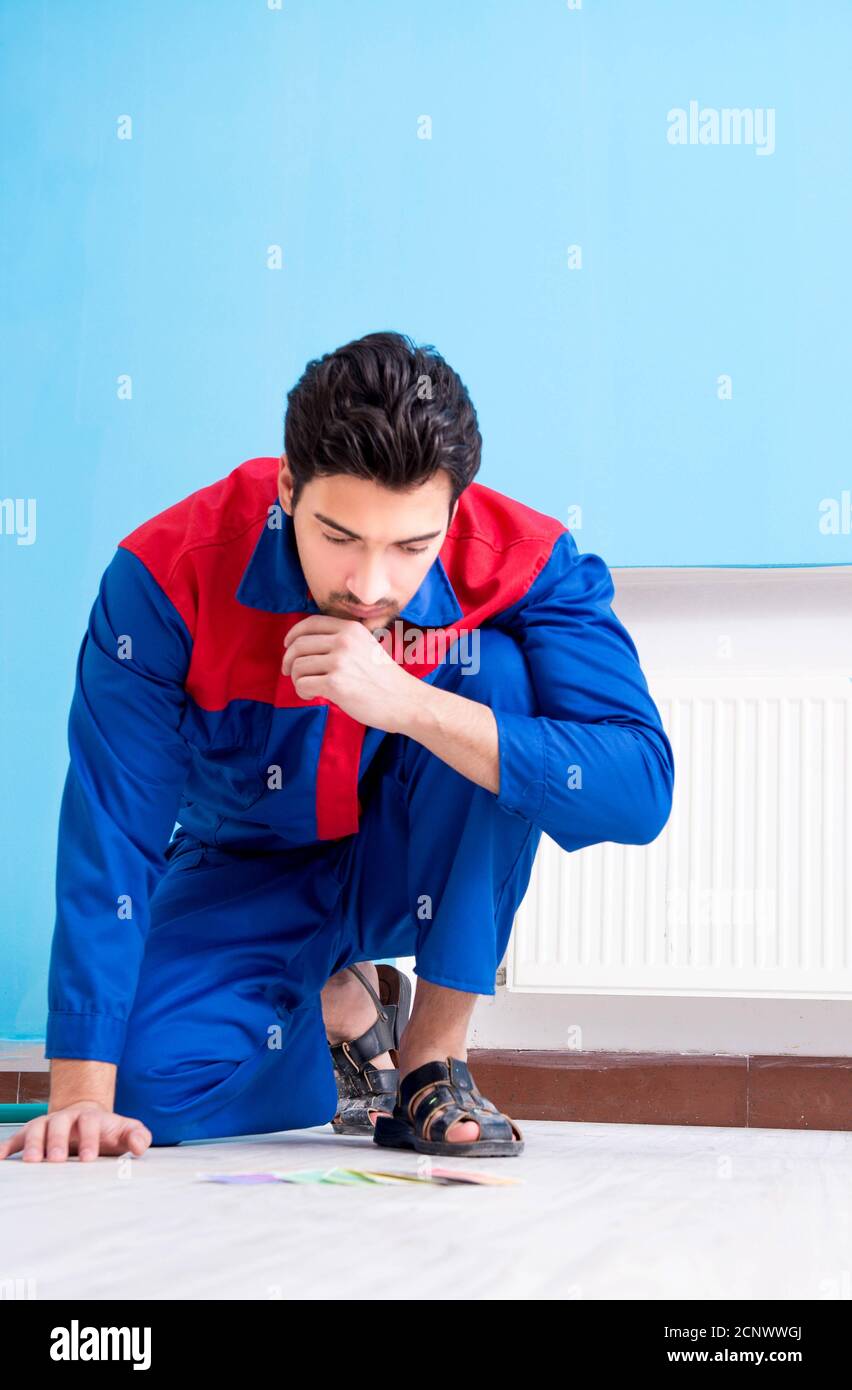 The young man contractor choosing color from rainbow Stock Photo - Alamy