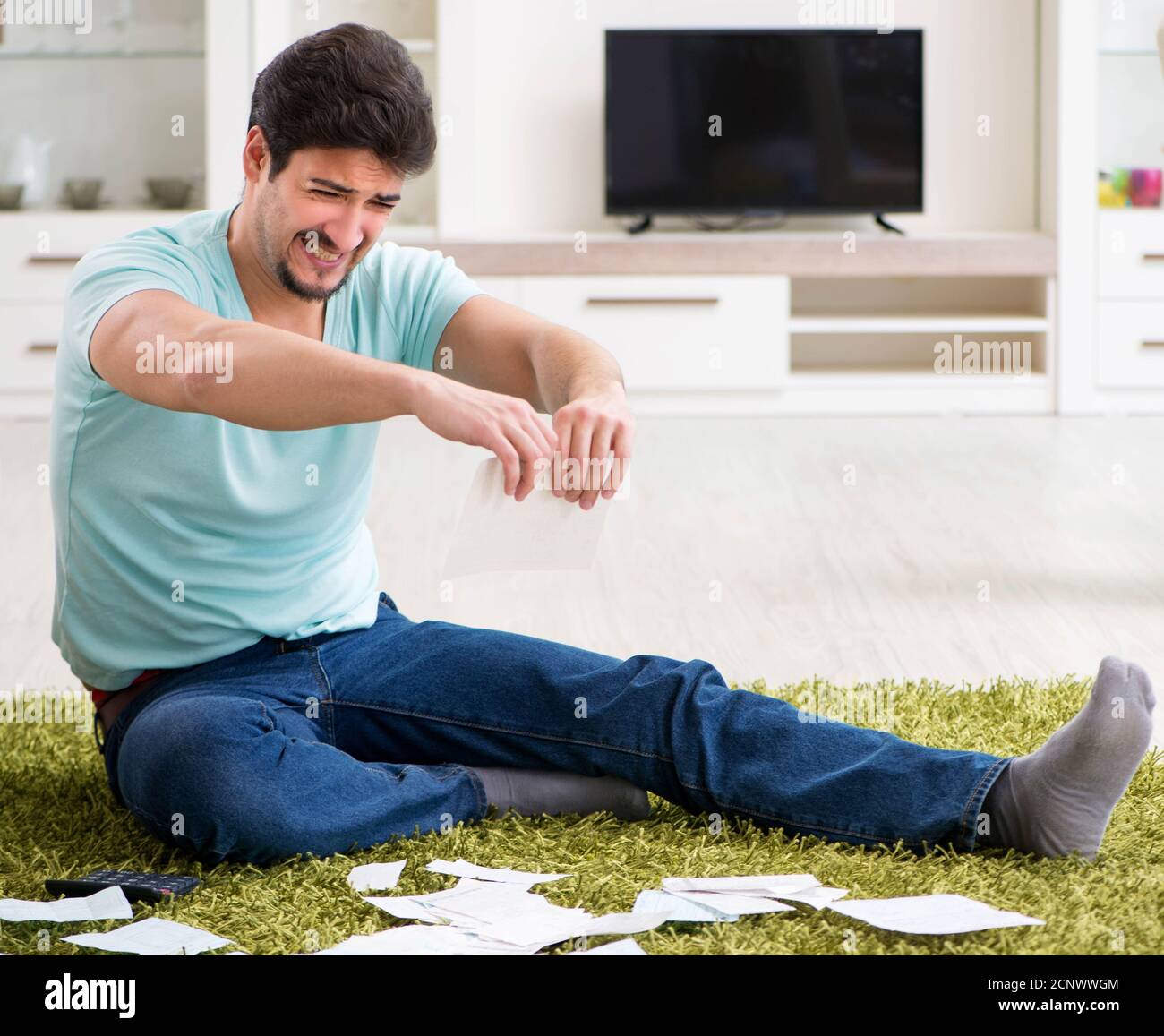 The young man struggling with personal finance and bills Stock Photo ...