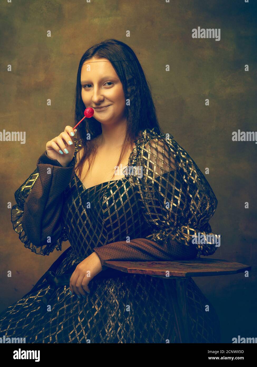 Candy. Young woman as Mona Lisa, La Gioconda isolated on dark green ...