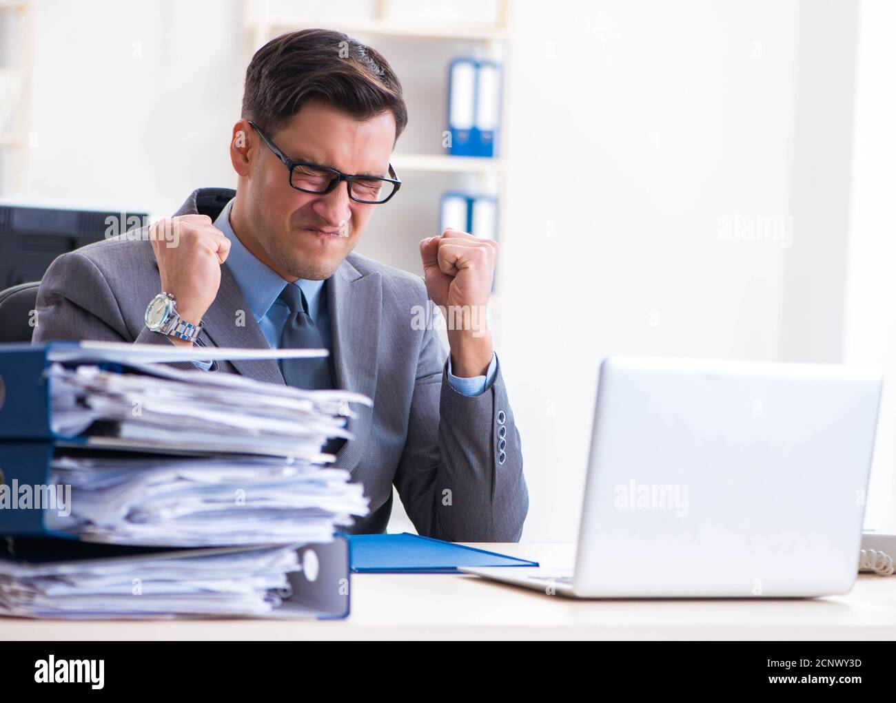 The overloaded with work employee under paperwork burden Stock Photo ...
