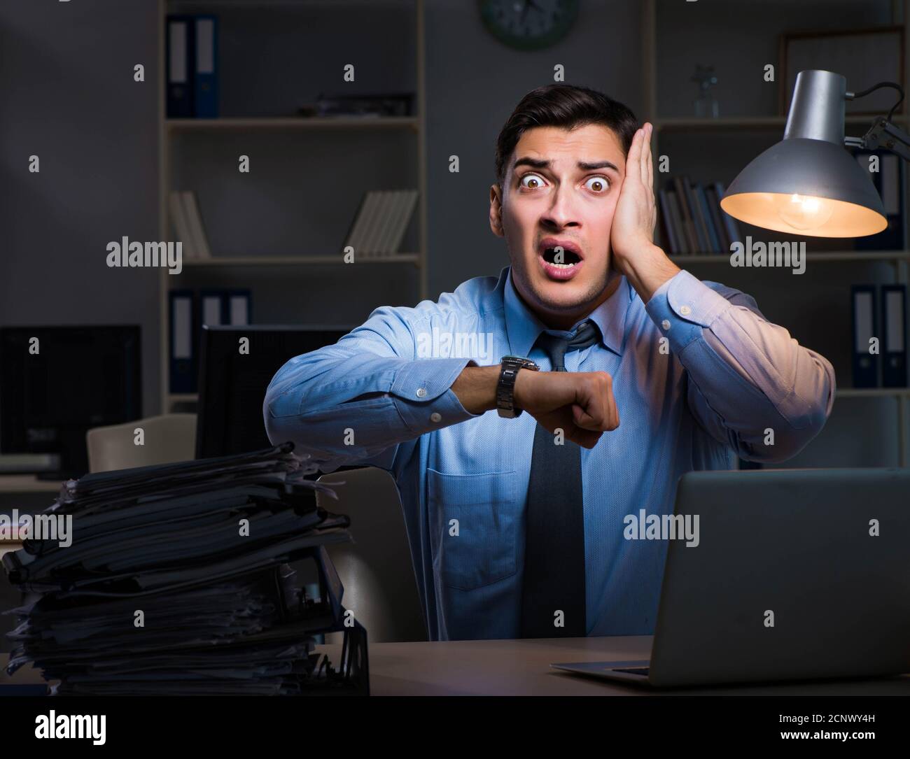The employee working late at night at important report Stock Photo - Alamy