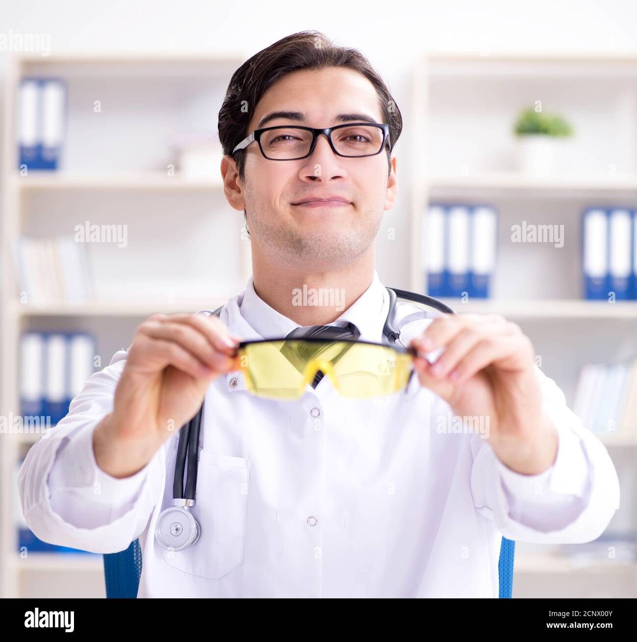 The safety doctor advising about wearing protective goggles Stock Photo ...