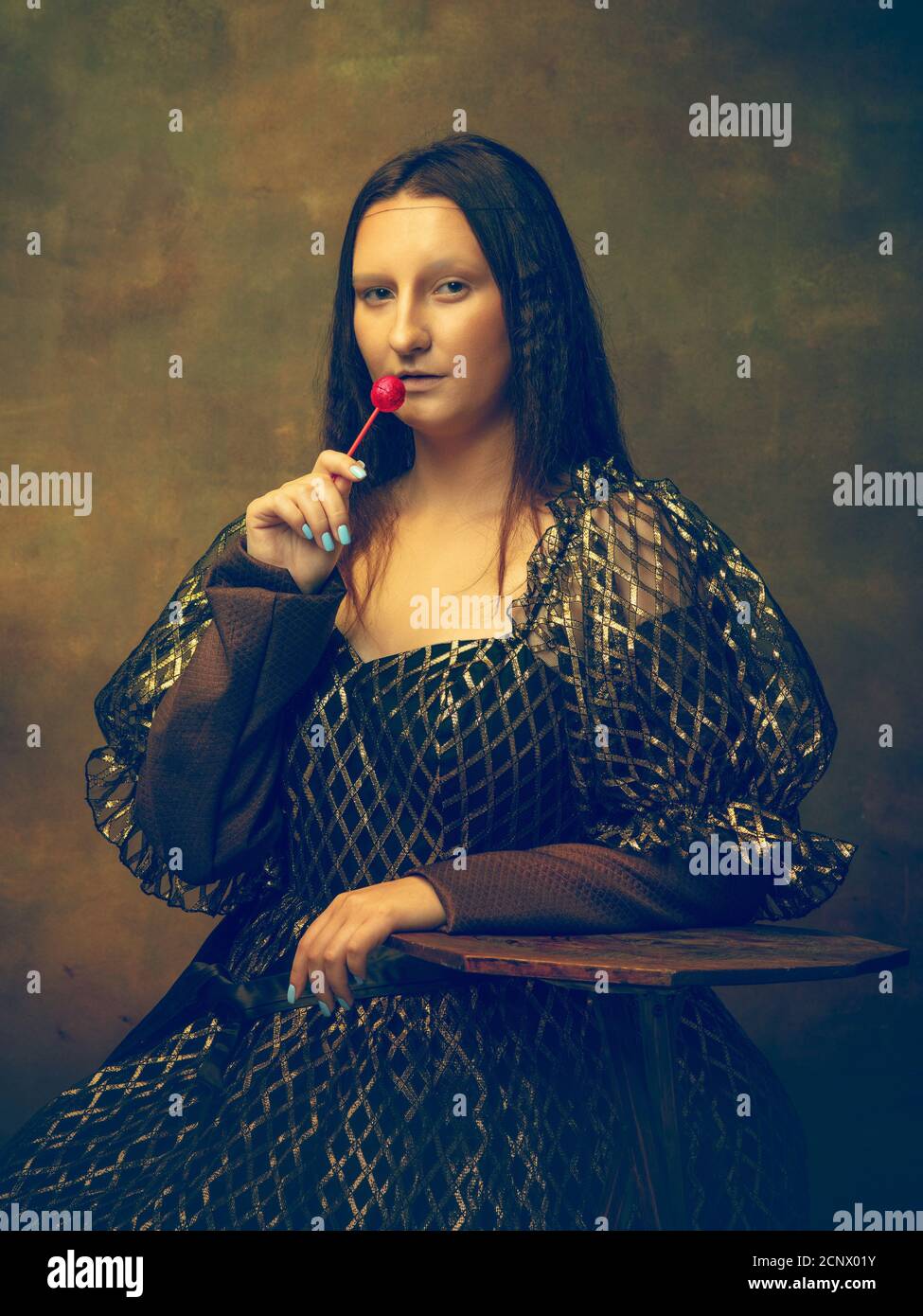 Candy. Young woman as Mona Lisa, La Gioconda isolated on dark green ...