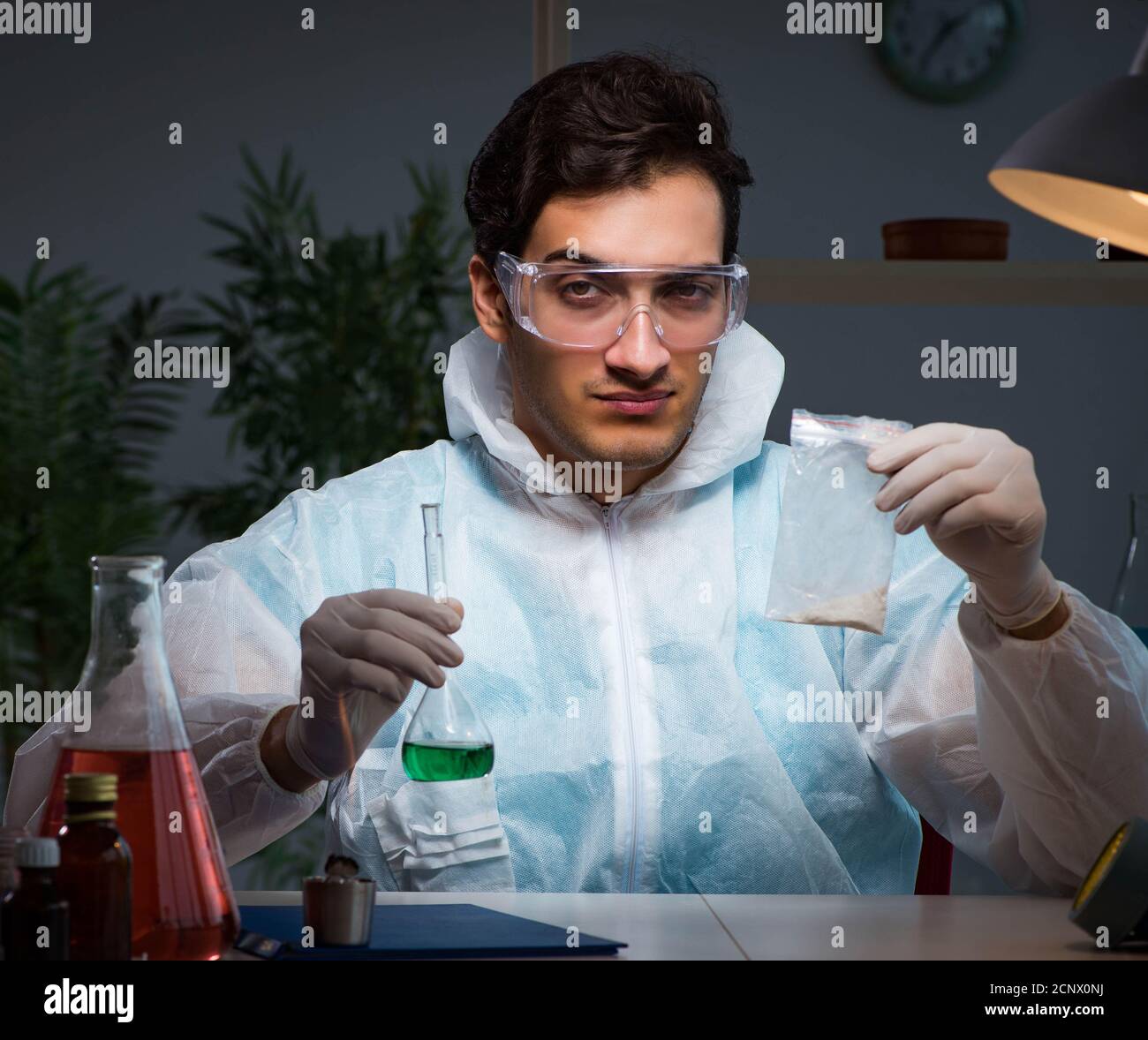 The forensic investigator working in lab looking for evidence Stock ...