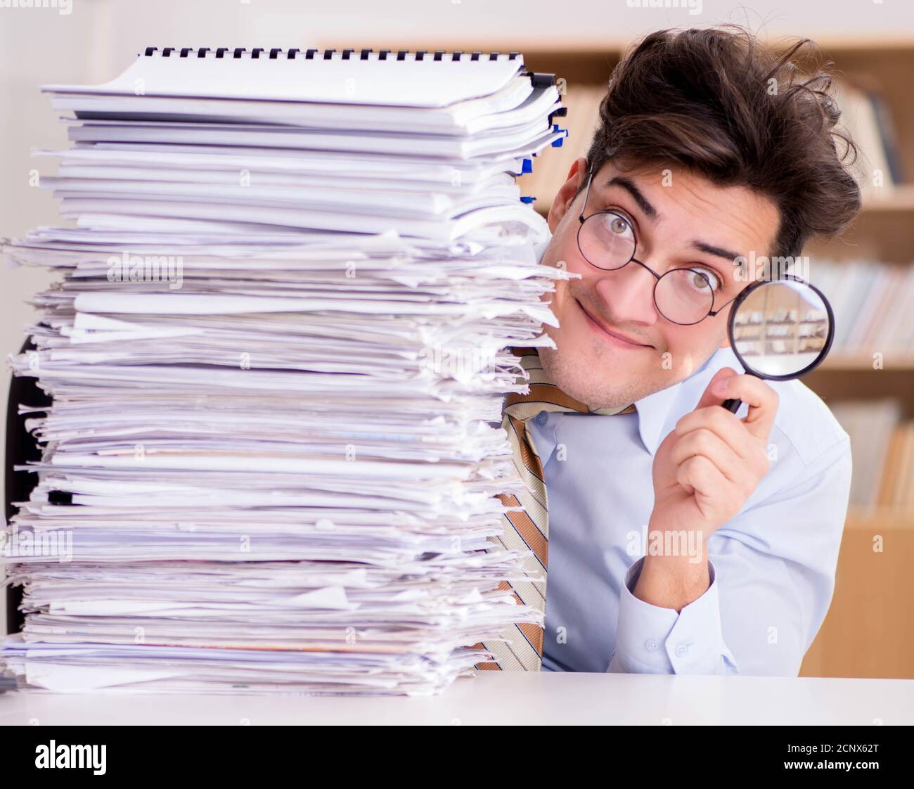 The funny auditor checking reports with magnifying glass Stock Photo ...