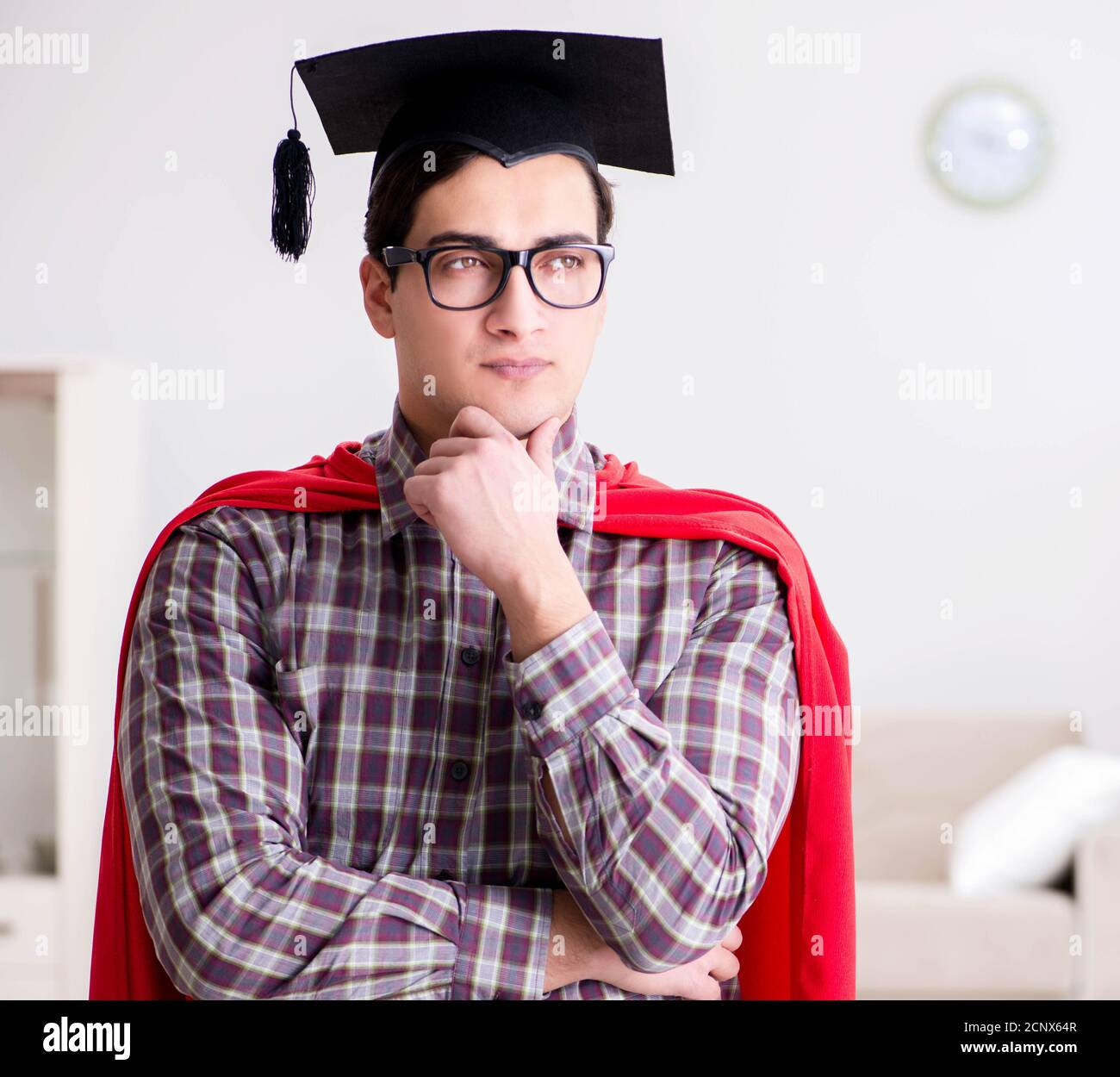 Super hero student wearing mortarboard in a red cloak Stock Photo - Alamy