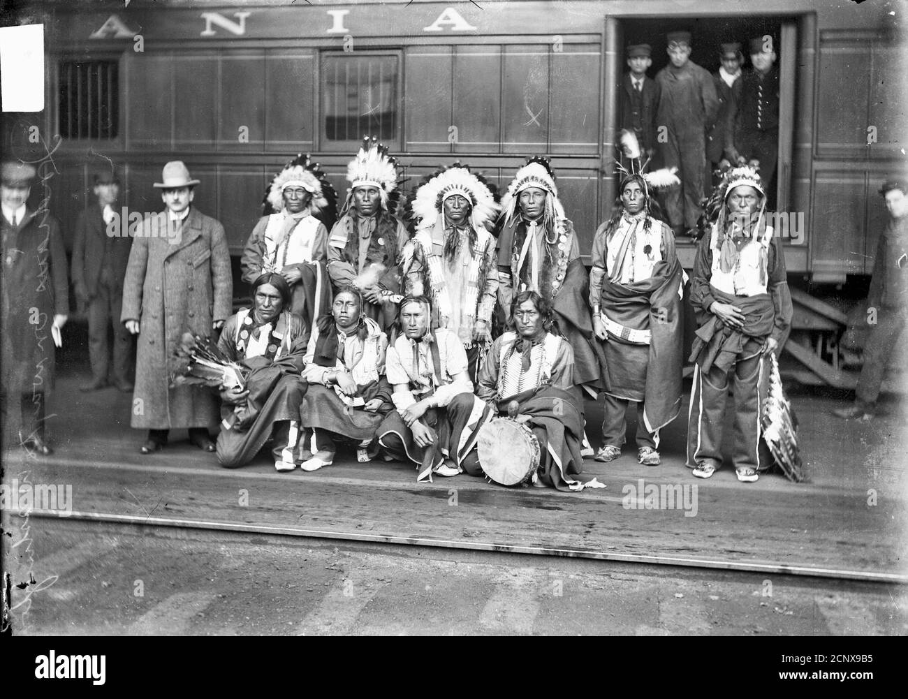 Native American Indians in traditional dress and gathered on a train ...