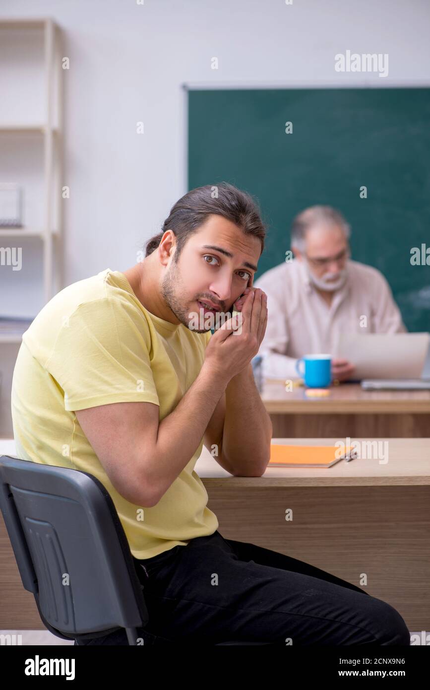 Old teacher and young student in the classroom Stock Photo - Alamy