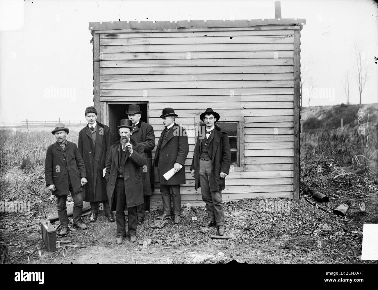 Captain George W. Streeter and five unidentified men standing in front ...