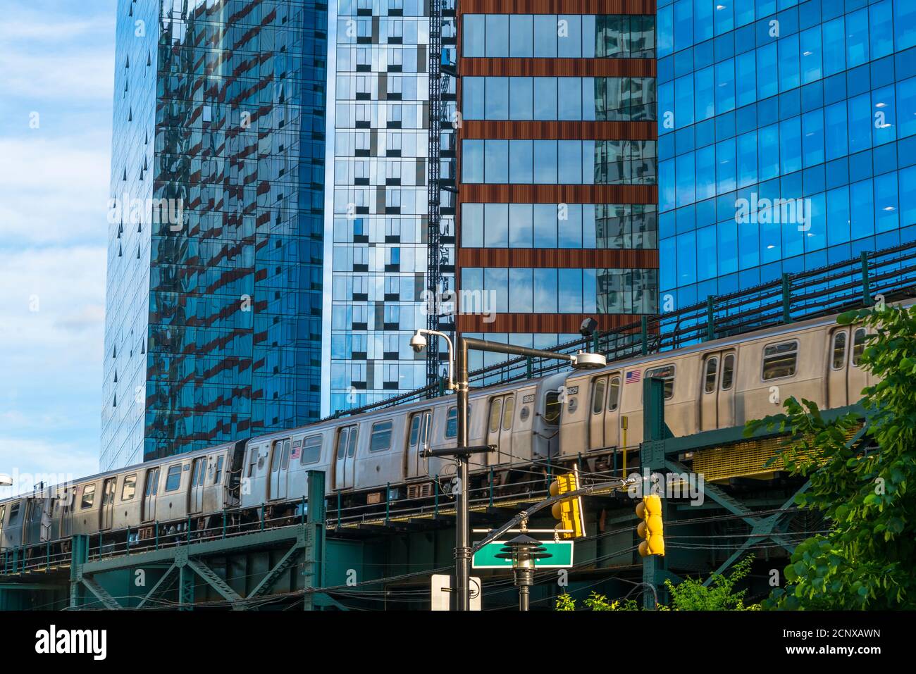 New York City subway runs on the elevated railway track at Queensboro ...