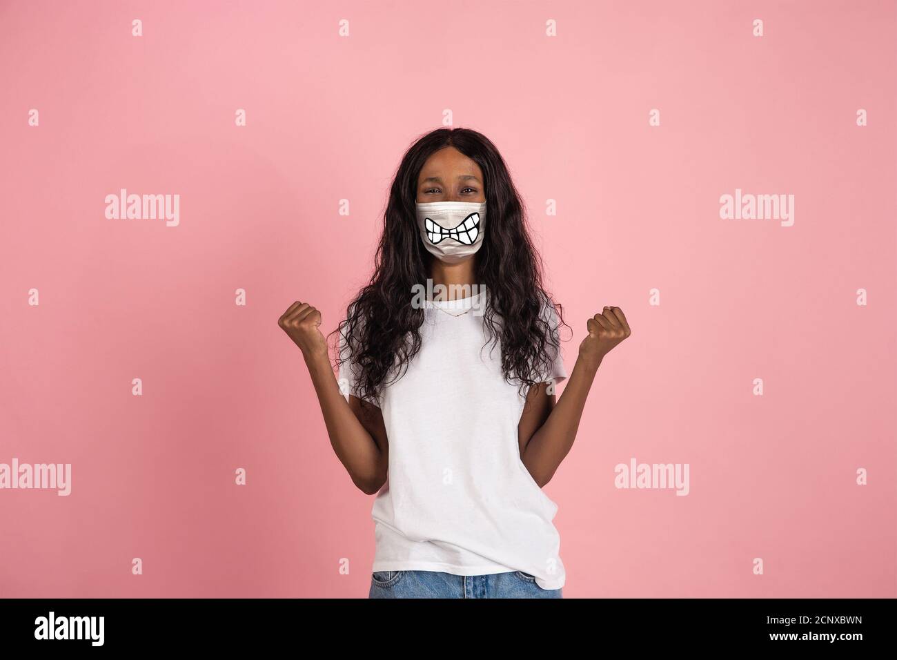 Crying. Portrait of young girl with emotion on her protective face mask ...