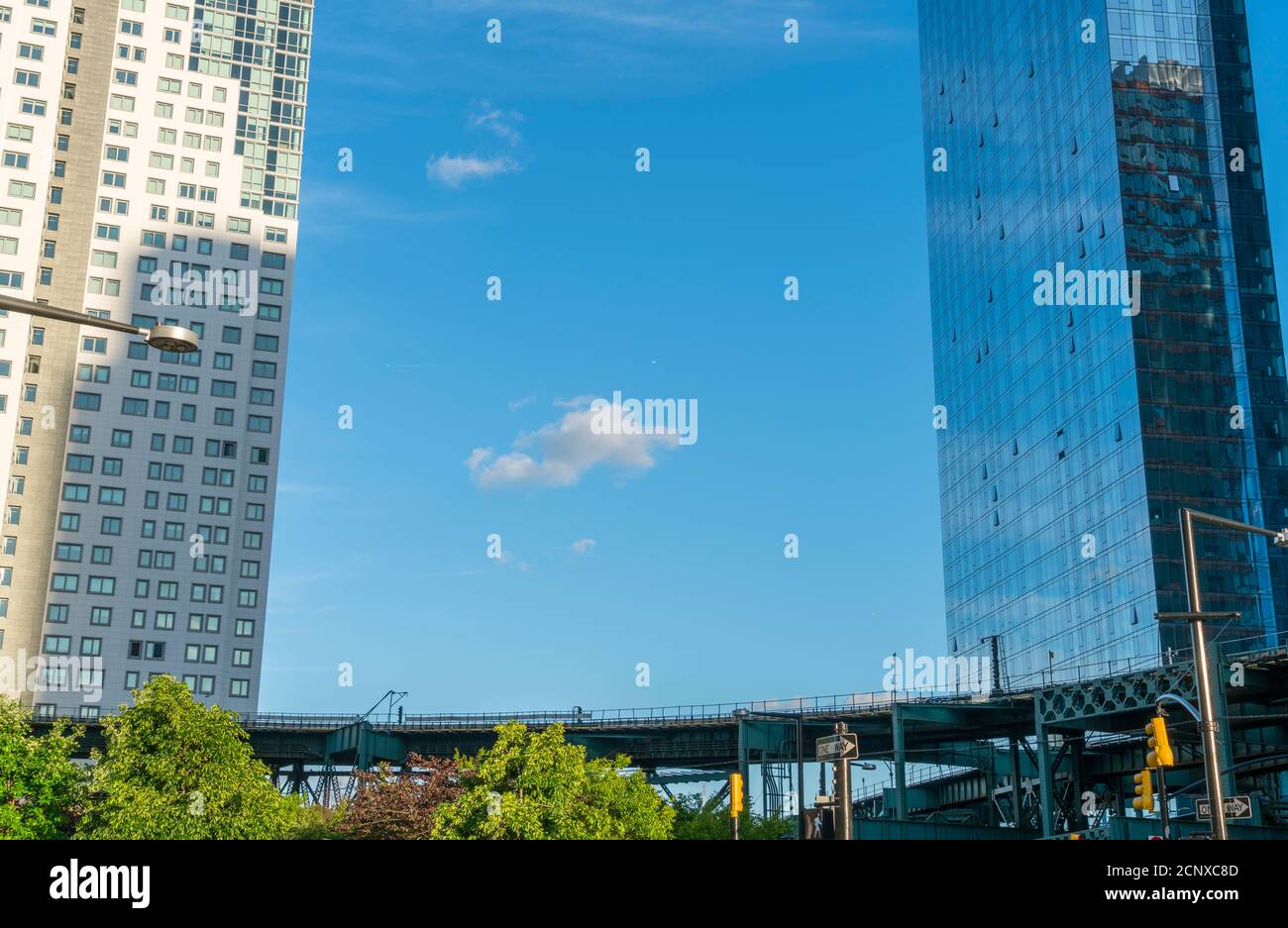 New York City subway runs on the elevated railway track at Queensboro ...