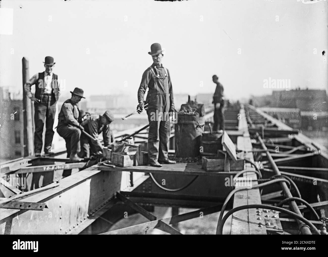 Five men constructing a portion of the Ravenswood line elevated train ...
