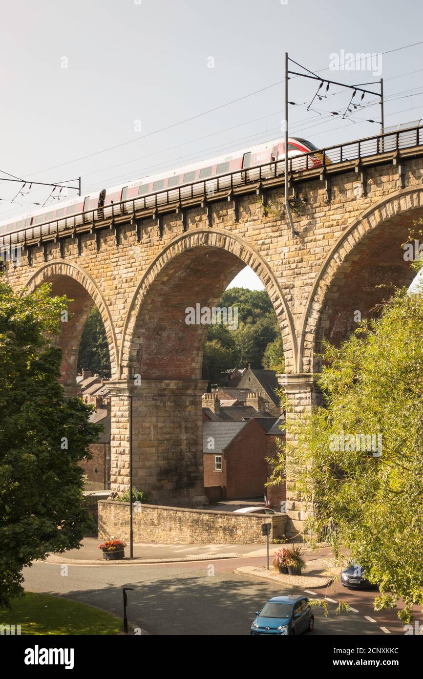 An LNER Hitachi Azuma train crosses the railway viaduct in Durham city ...