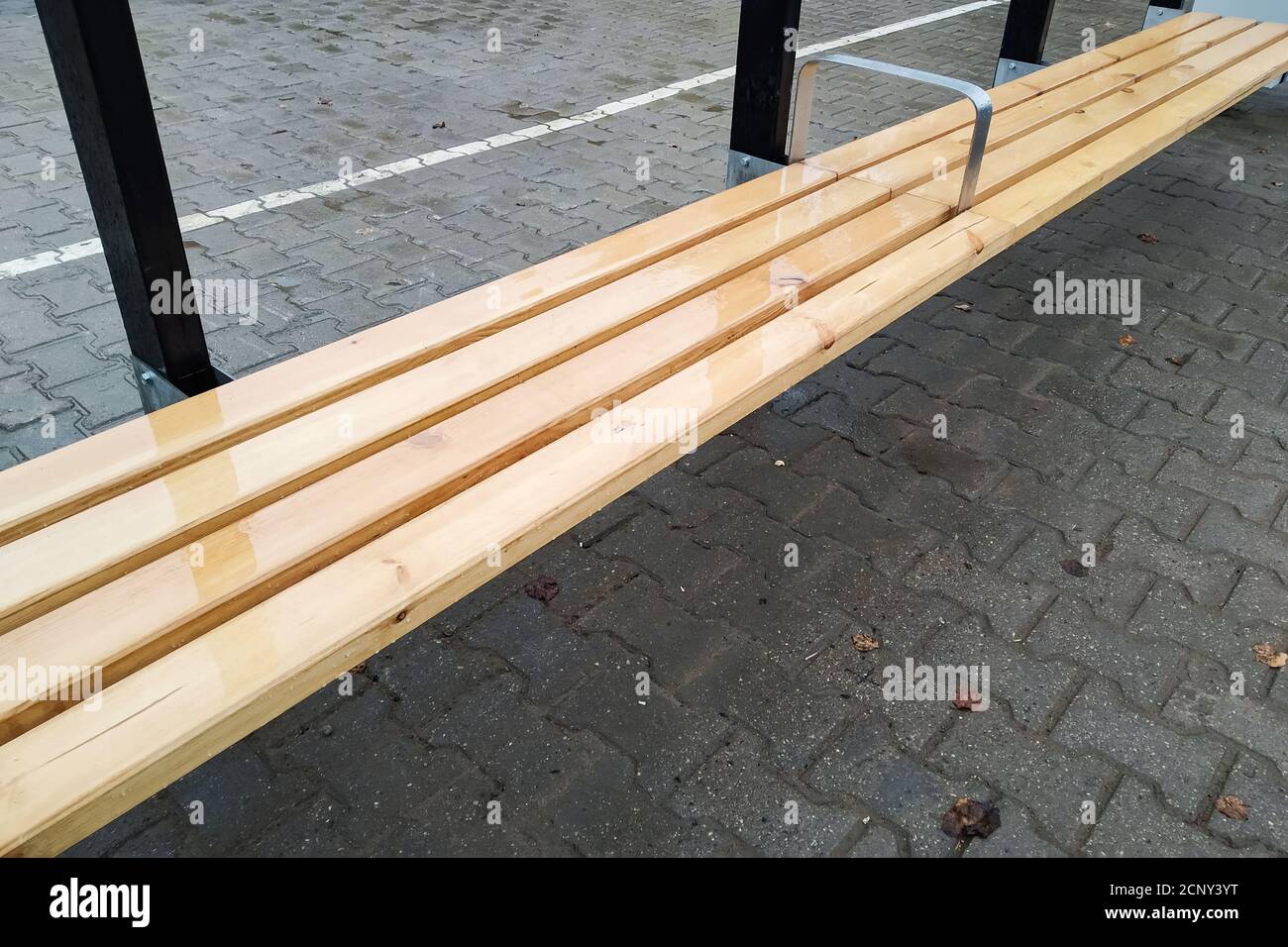 Wooden bench at a bus stop closeup Stock Photo - Alamy