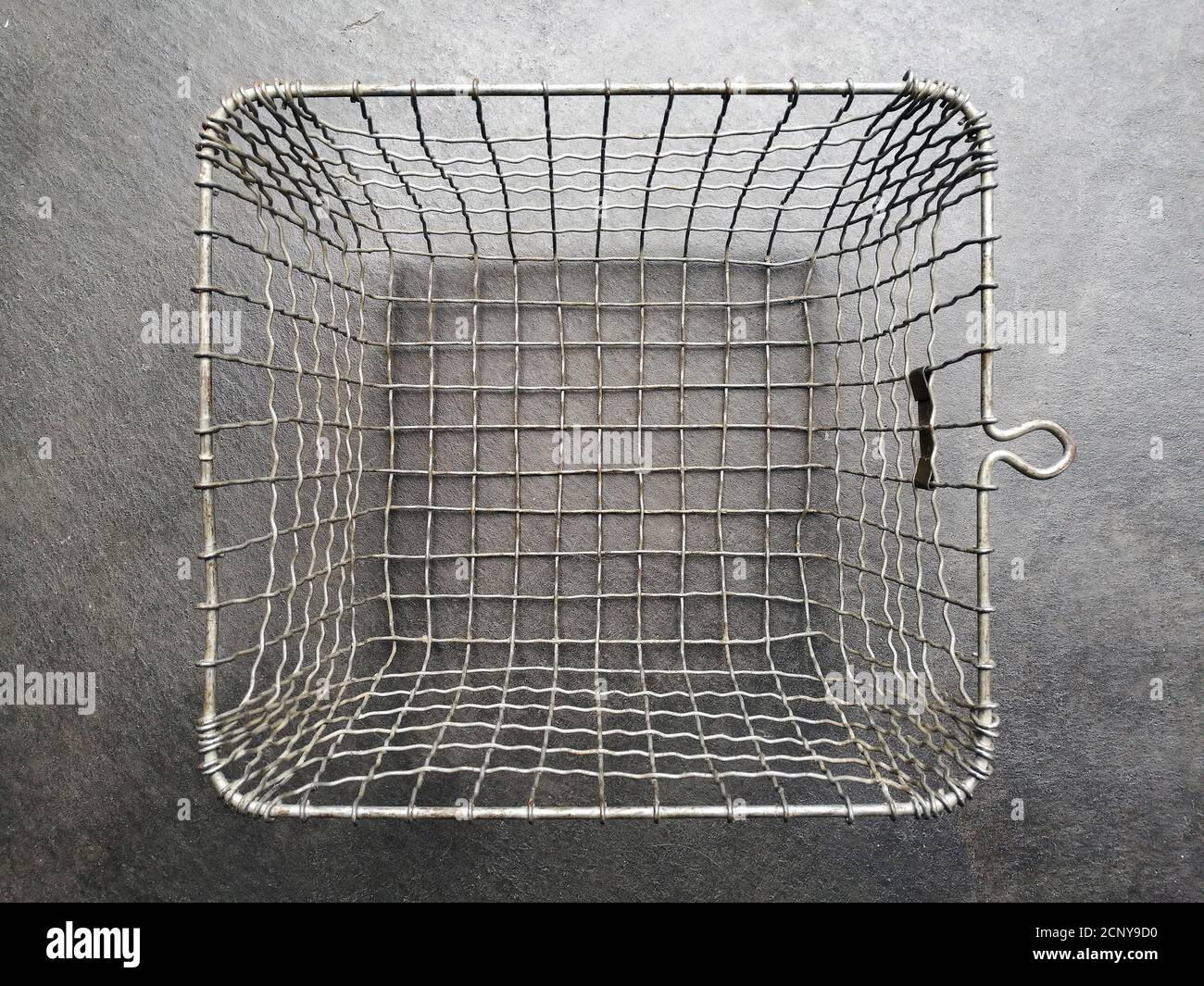 Empty wire basket on gray background Stock Photo - Alamy
