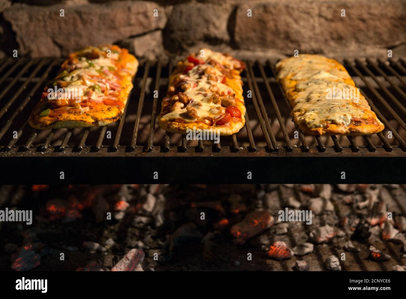 Rustic pizza cooked on grill for dinner Stock Photo - Alamy