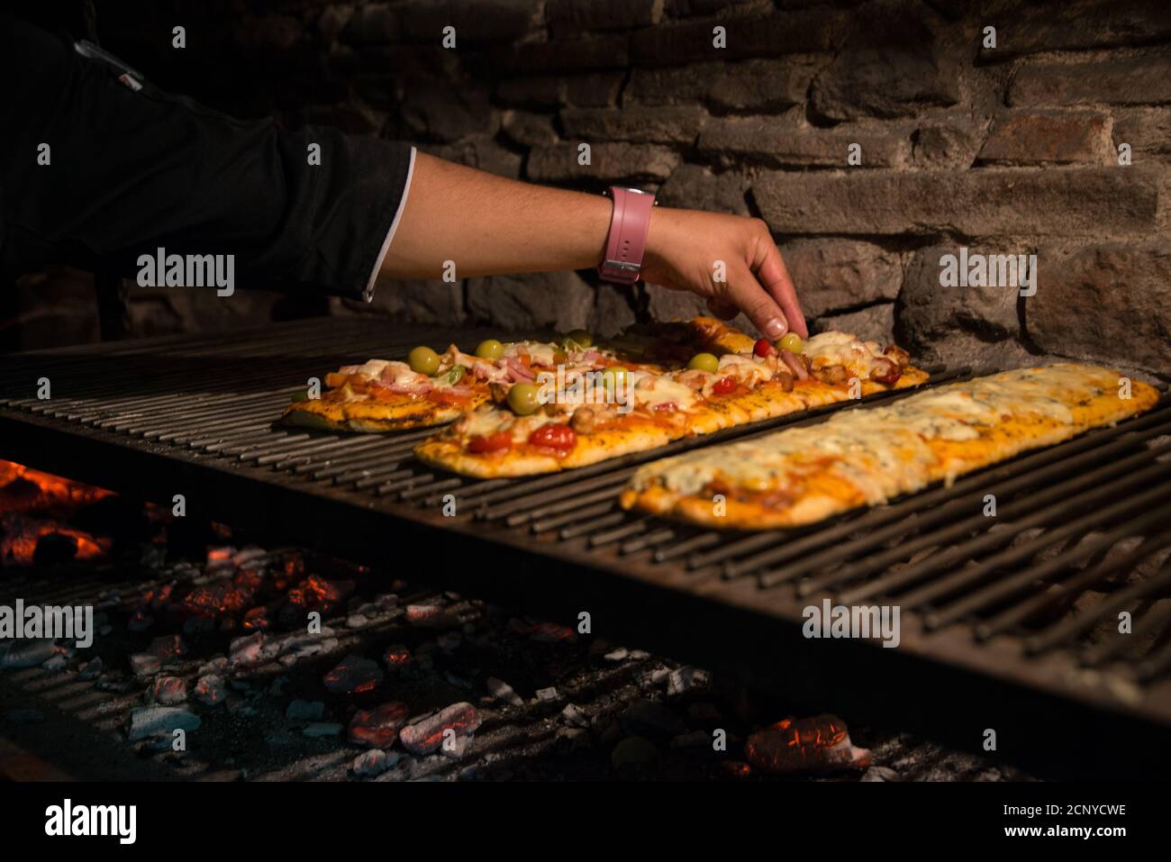Rustic pizza cooked on grill for dinner Stock Photo - Alamy