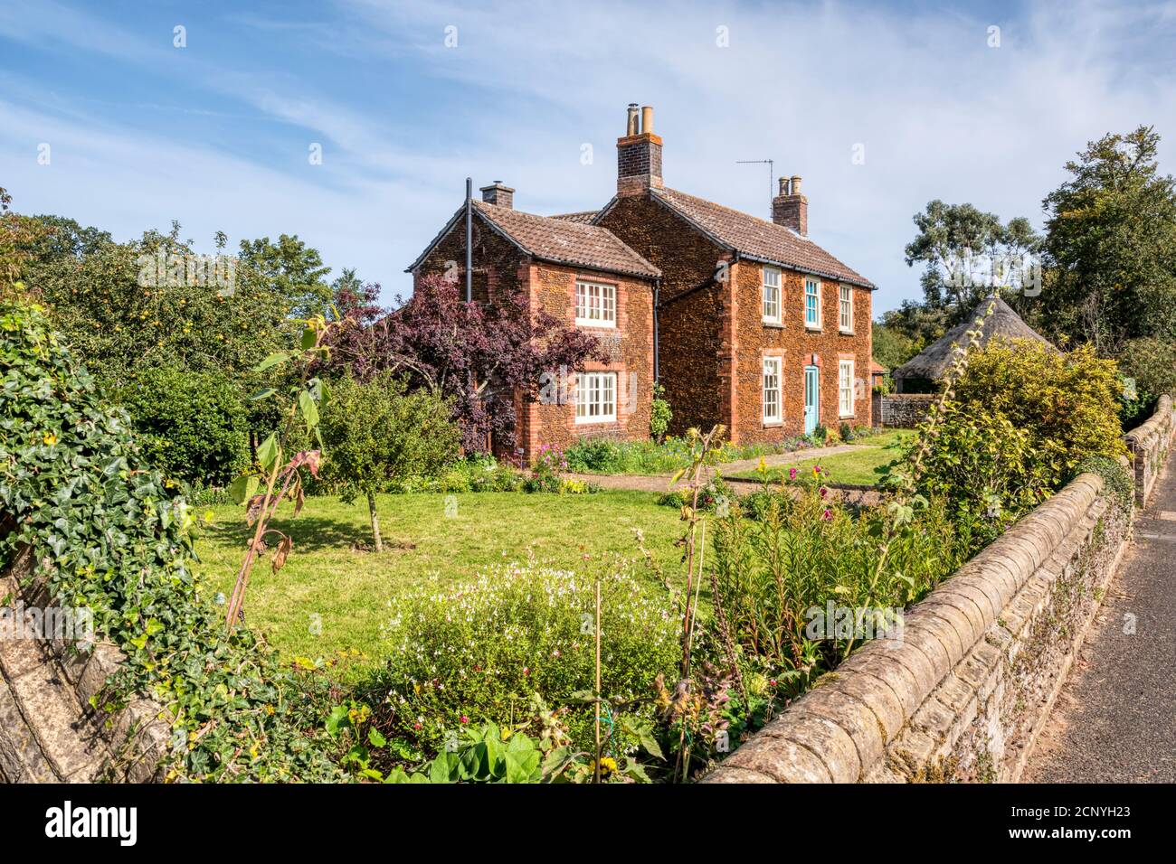 A large house built of carstone in the Norfolk estate village of West ...