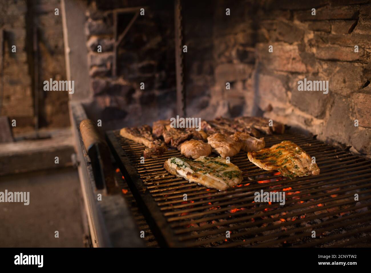 Beef and fish meat roasting on the grill Stock Photo - Alamy