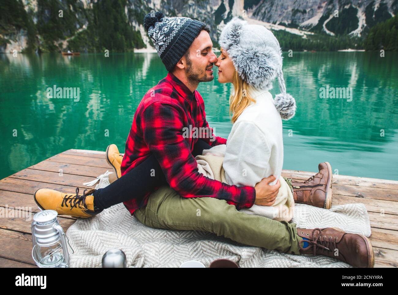 Beautiful couple of young adults visiting an alpine lake at Braies ...