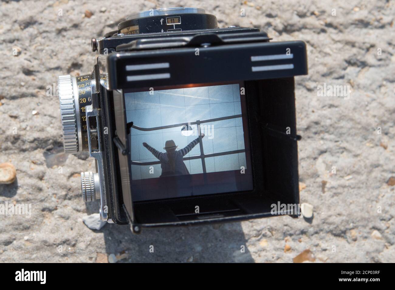 A vintage Rolleiflex twin reflex camera framing a subject in a beach ...