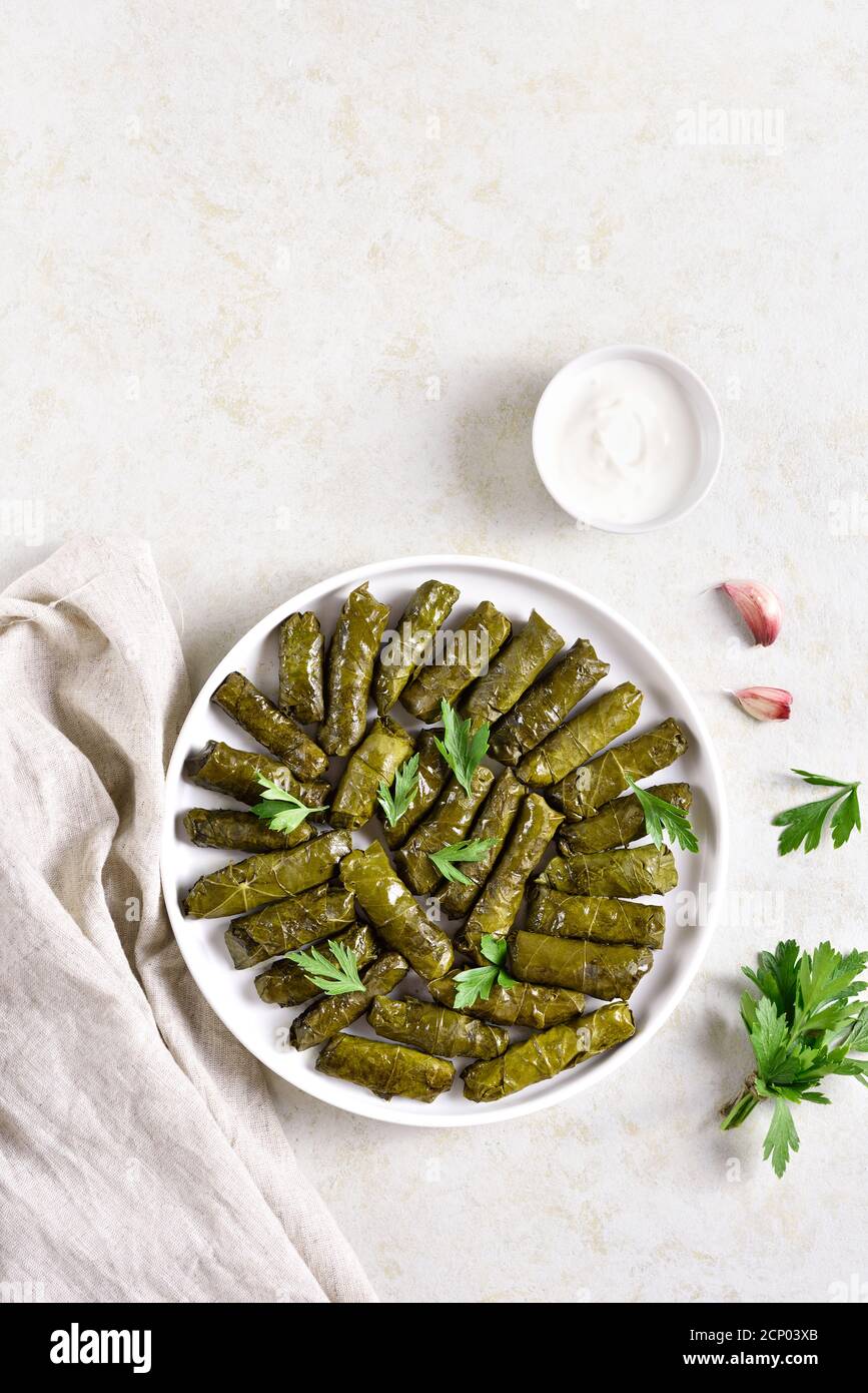 Dolma, stuffed grape leaves with rice and meat on light stone ...