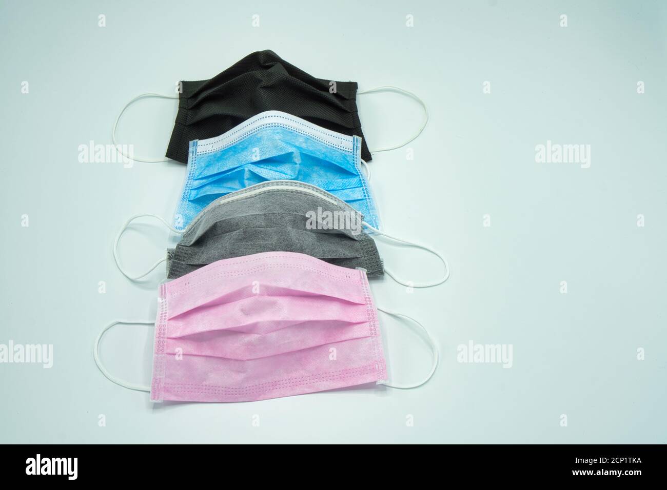 Face masks of different colors on white background with copy space ...
