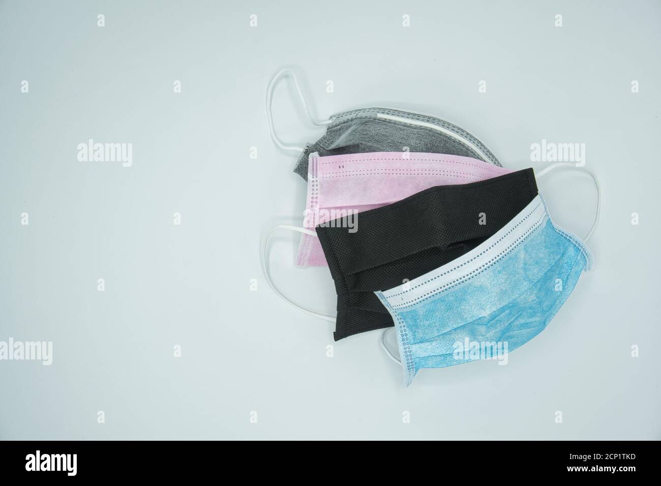 Face masks of different colors on white background with copy space ...