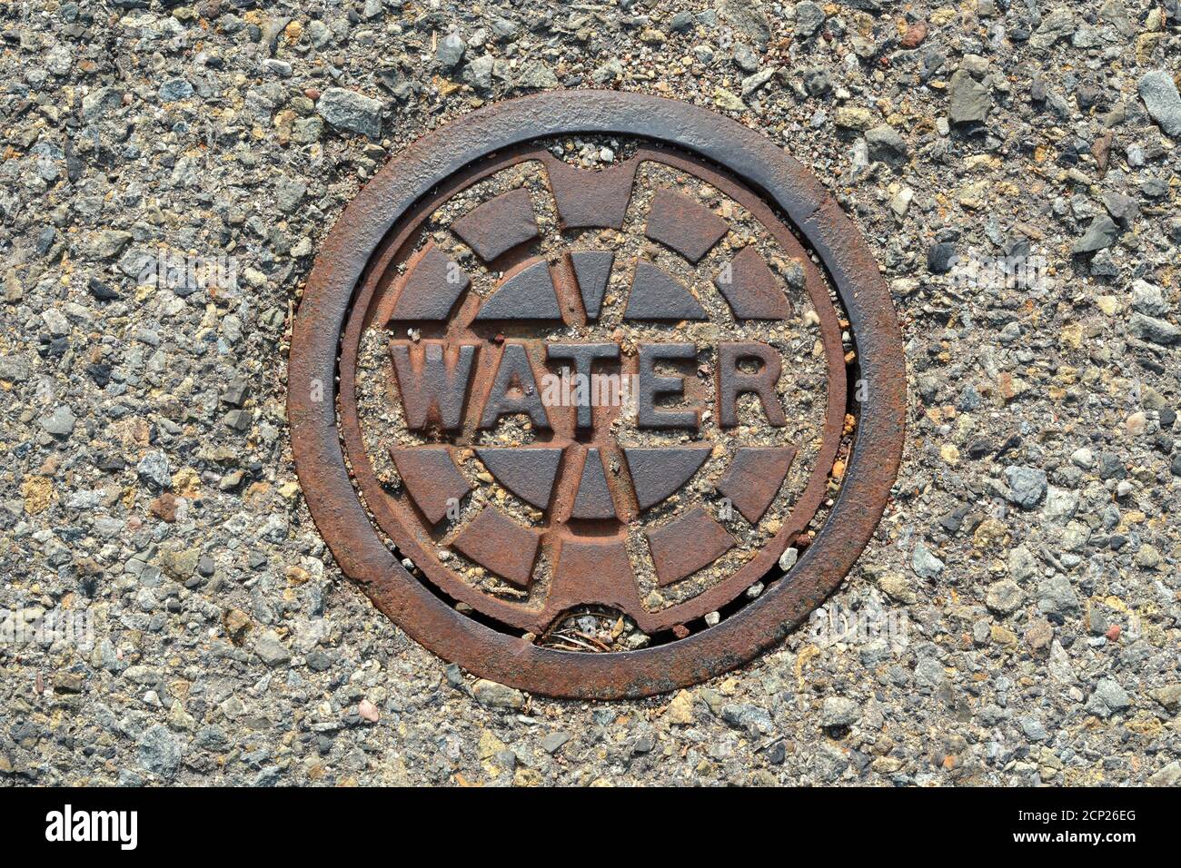 The cast iron cover of a public water main in a road in Santa Fe, New ...