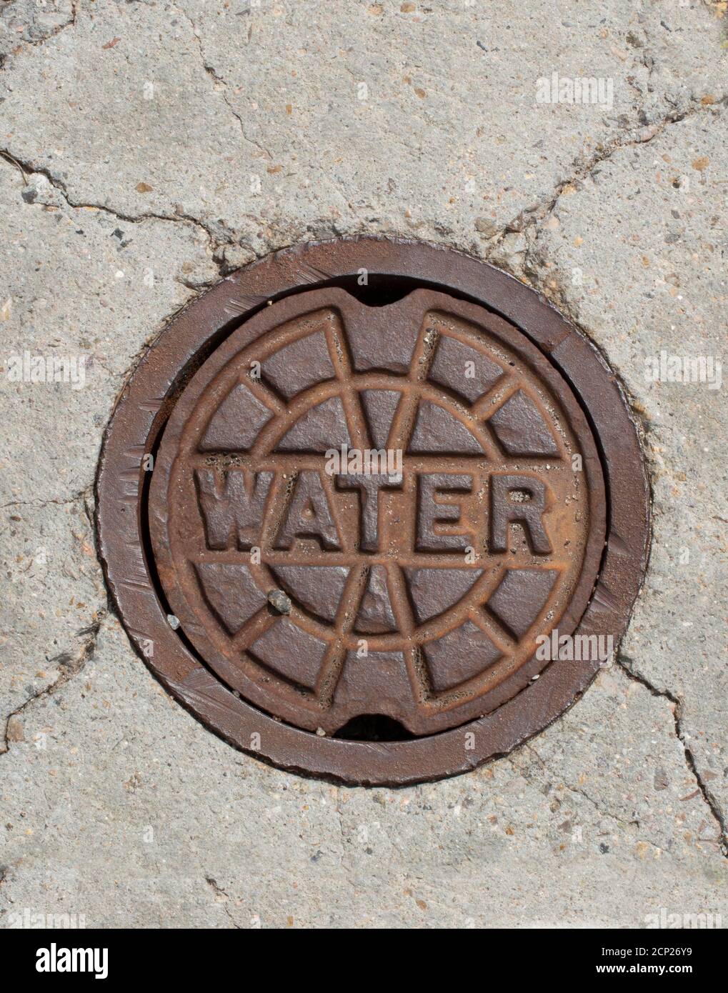 The cast iron cover of a public water main in a road in Santa Fe, New ...