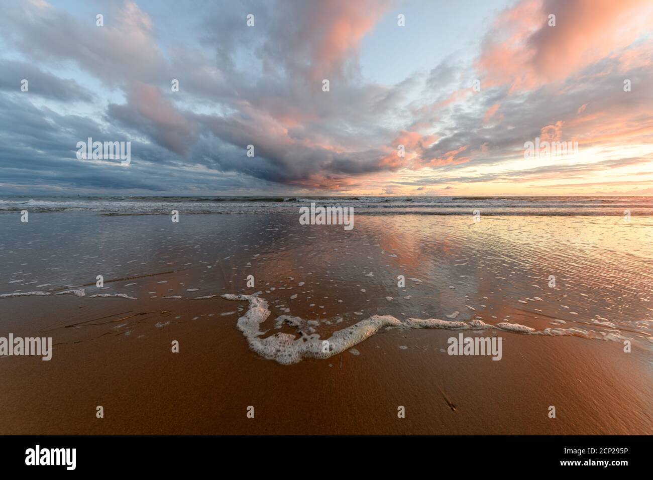 Sunset at the atlantic Ocean with orange beach and sky in France Stock ...